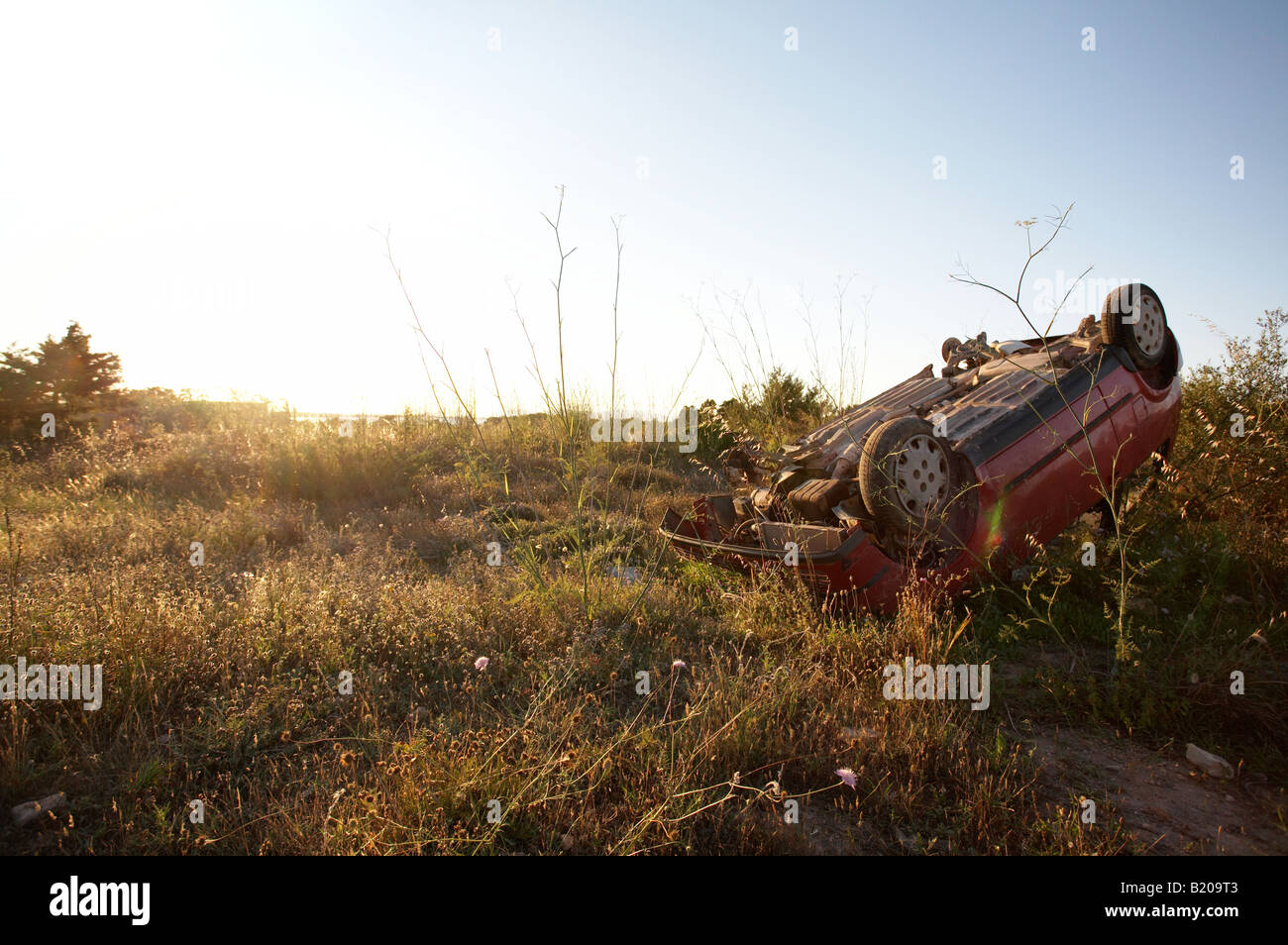 overturned abandoned car in a field on Formentera Balaeric Islands ...