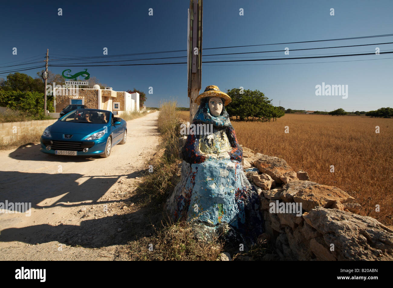 tourists in a blue Peugeot car in Formentera Balaeric Islands Spain ...