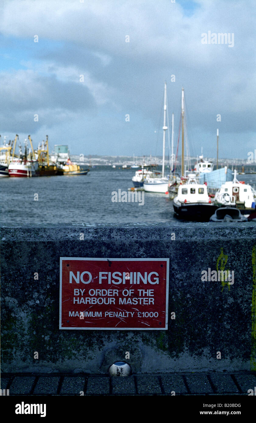Sign on the harbour wall at Brixham Devon Stock Photo - Alamy