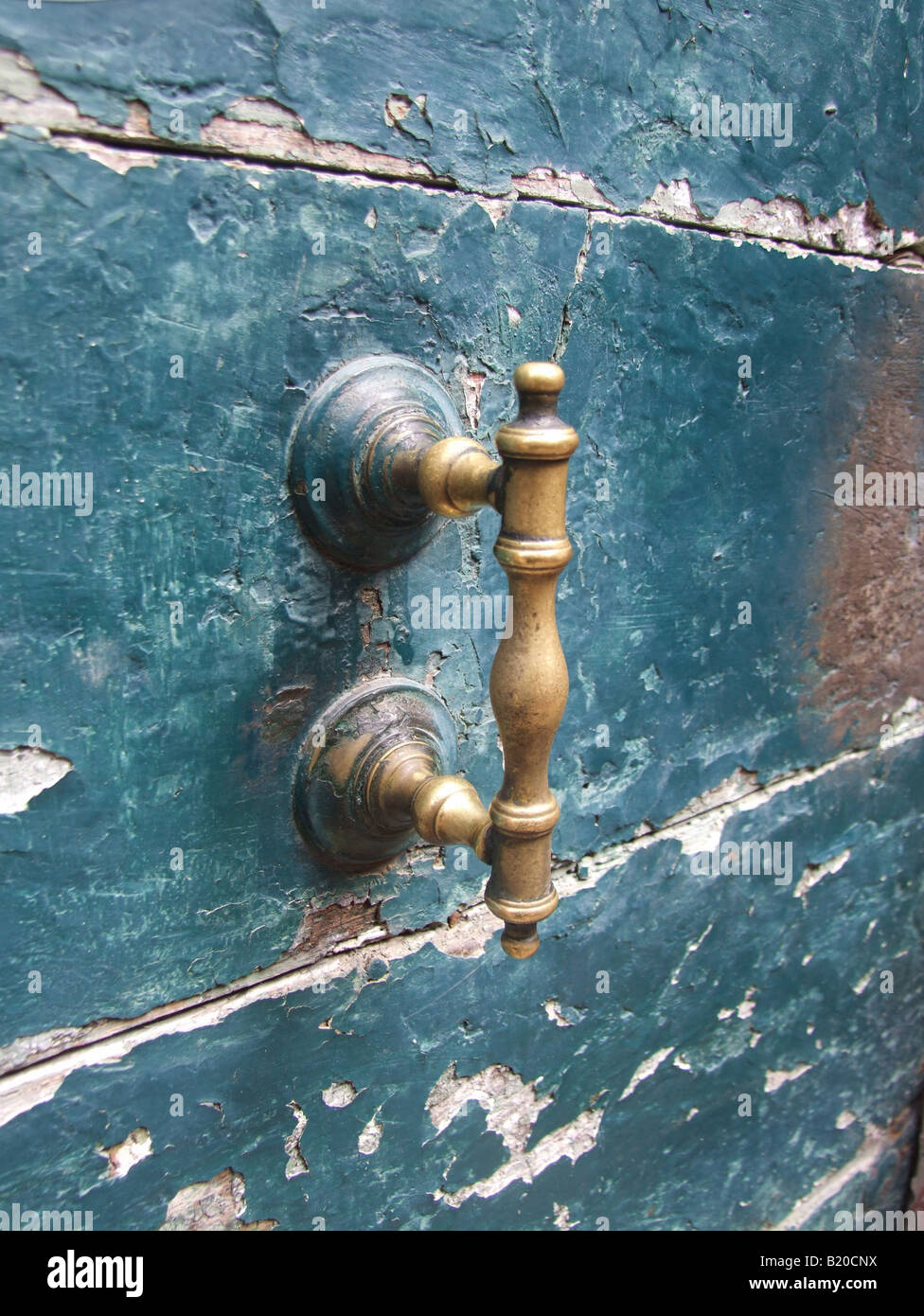 one brass handle on old green house door Stock Photo - Alamy