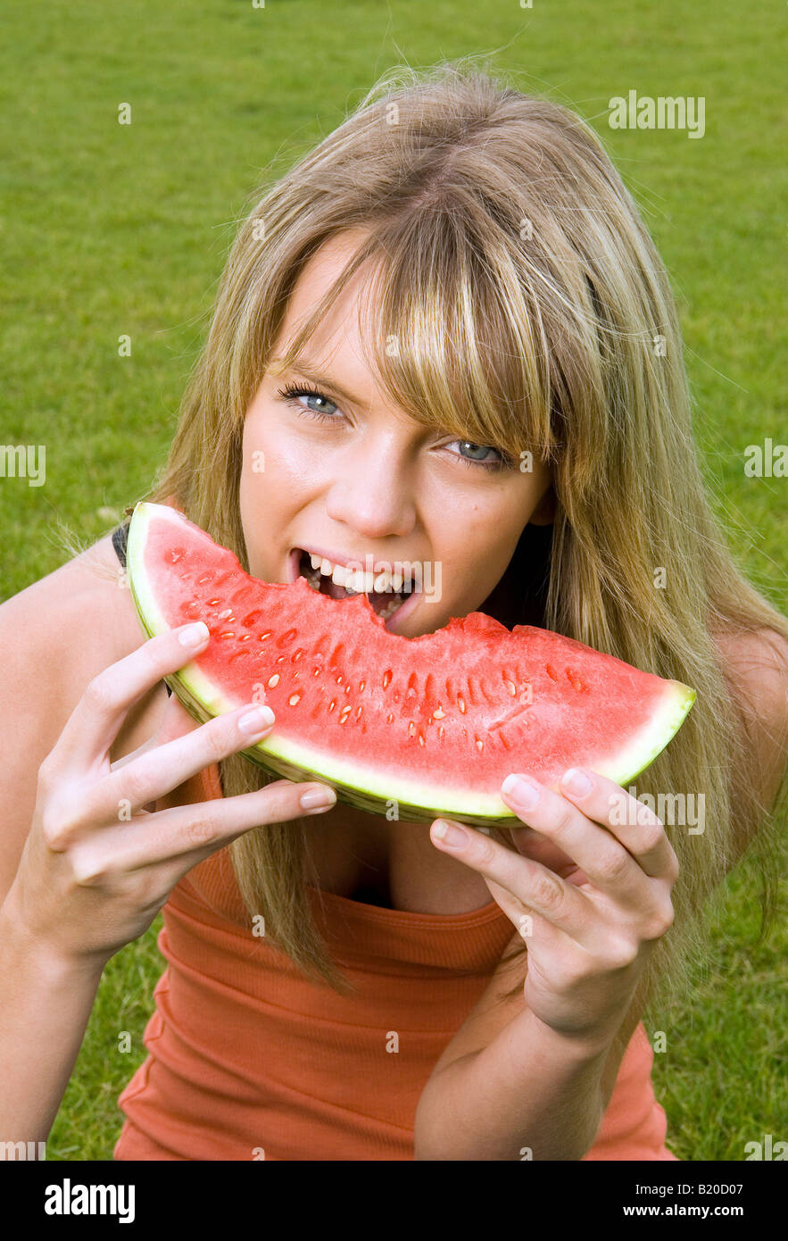 Young woman eating a watermelon Stock Photo - Alamy