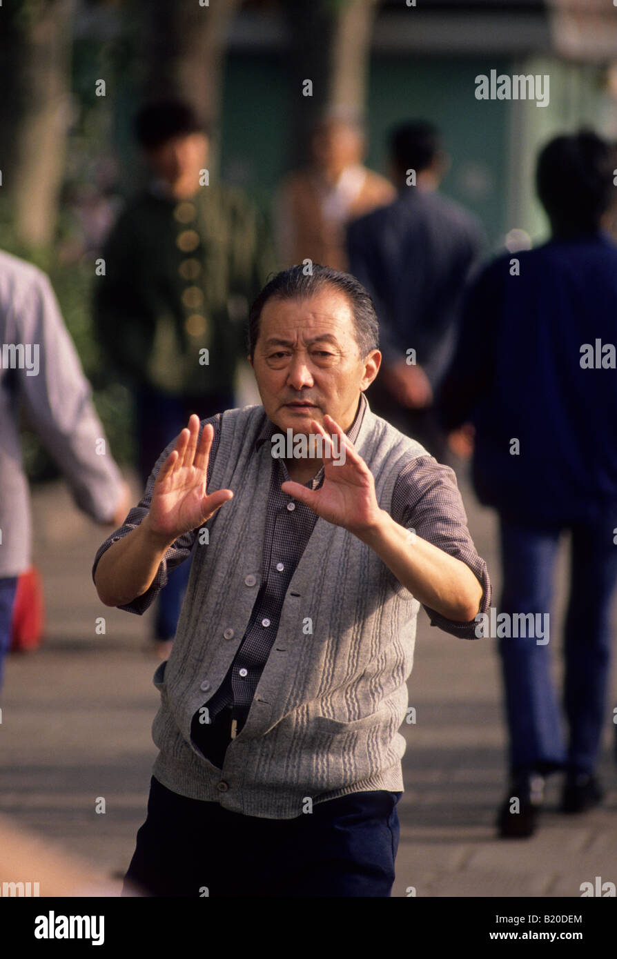 A Chinese man performs tai chi exercises in a park in Shanghai China ...