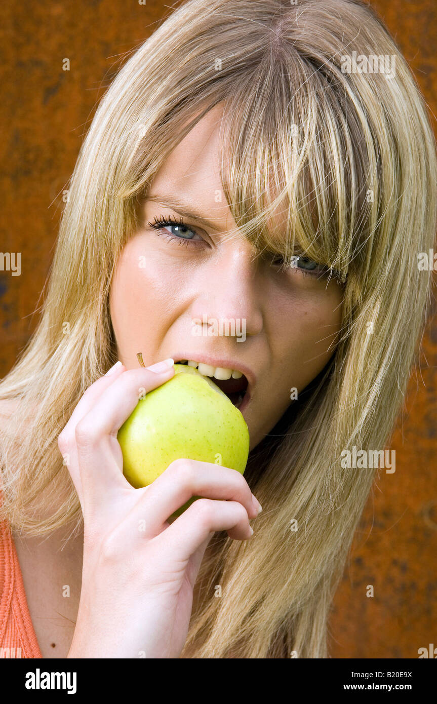 Young woman eating an apple Stock Photo - Alamy