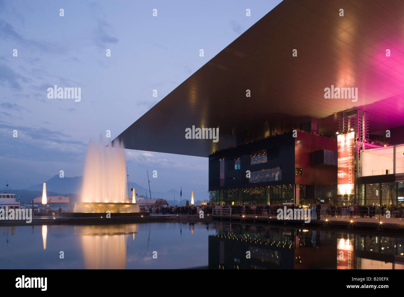 Illuminated fountain and KKL culture and congress centre of Lucerne at ...