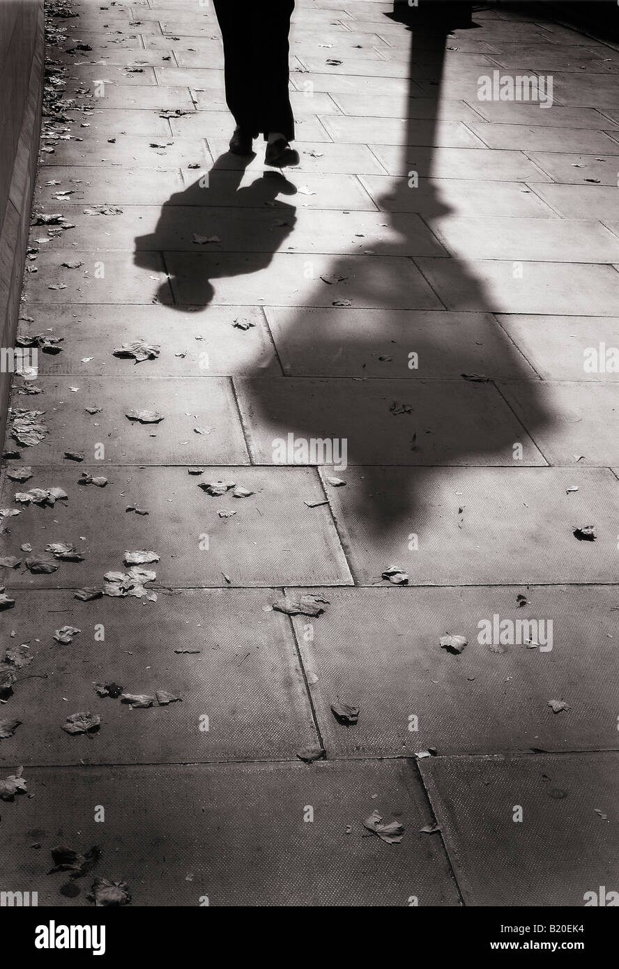 man walking on sidewalk Stock Photo - Alamy