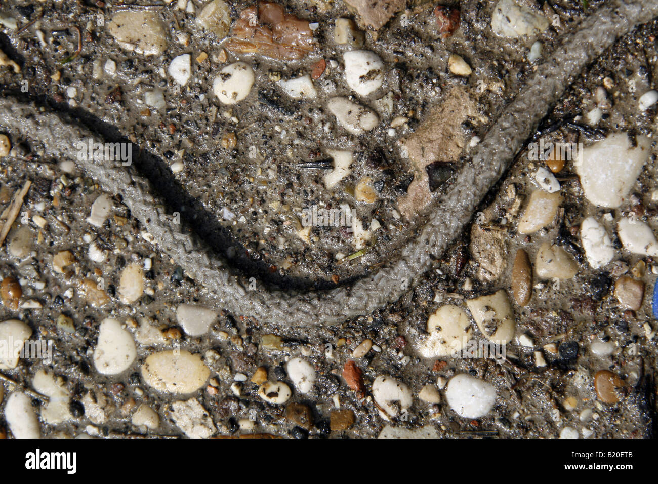 detail of dirty rope stuck in mud soil Stock Photo - Alamy
