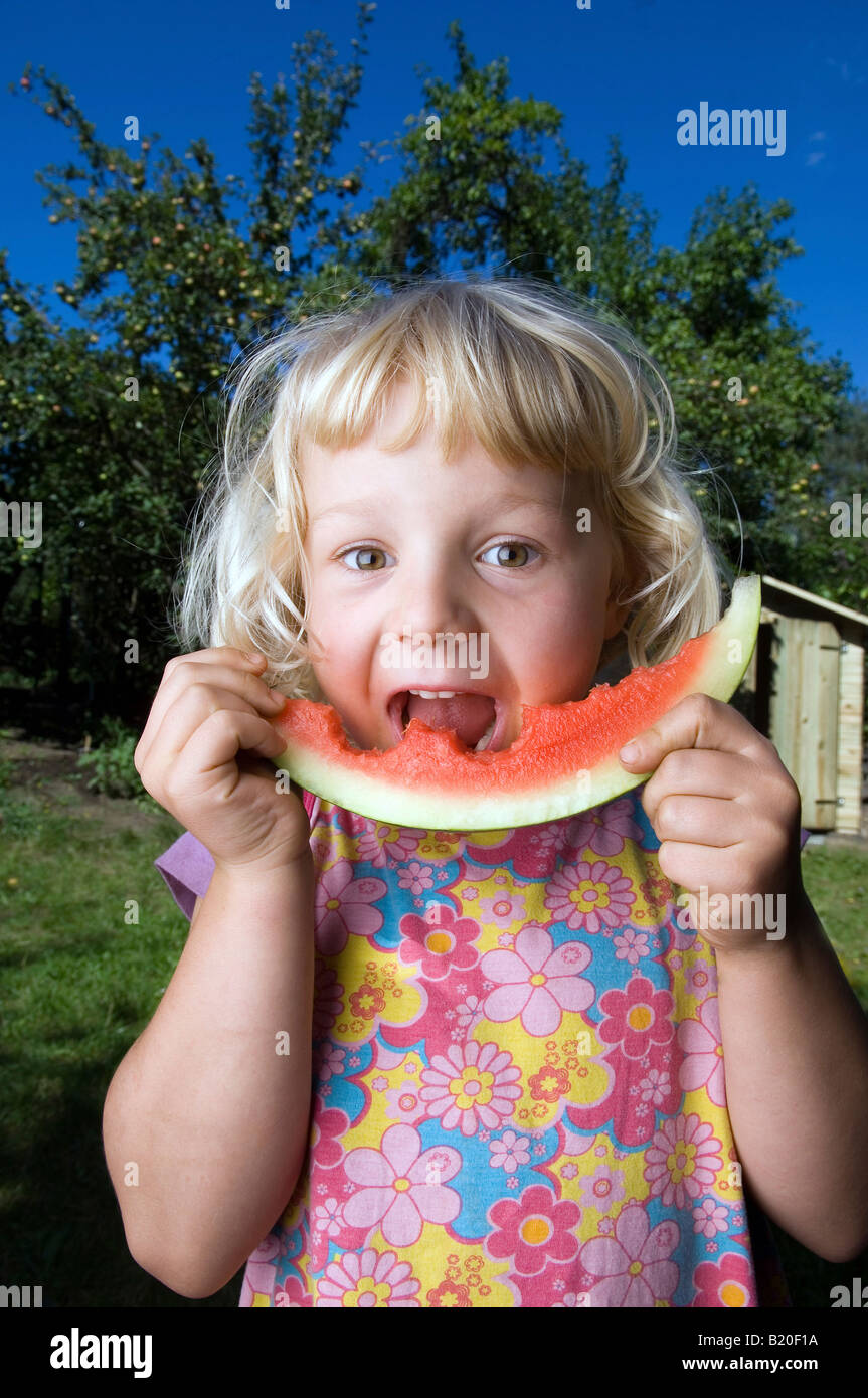 Kid eating a watermelon Stock Photo - Alamy