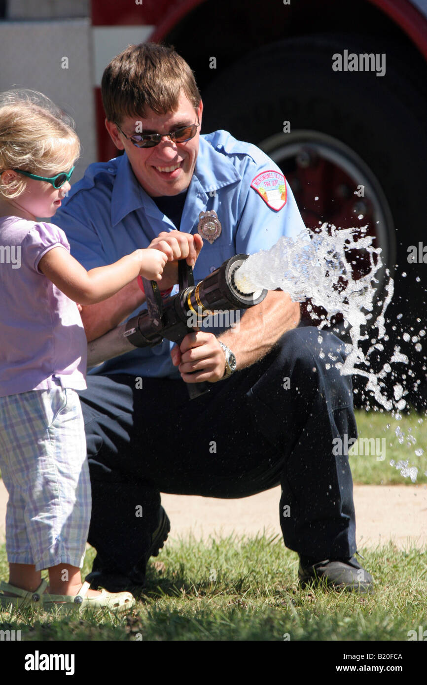 Firefighter using hose hi-res stock photography and images - Alamy