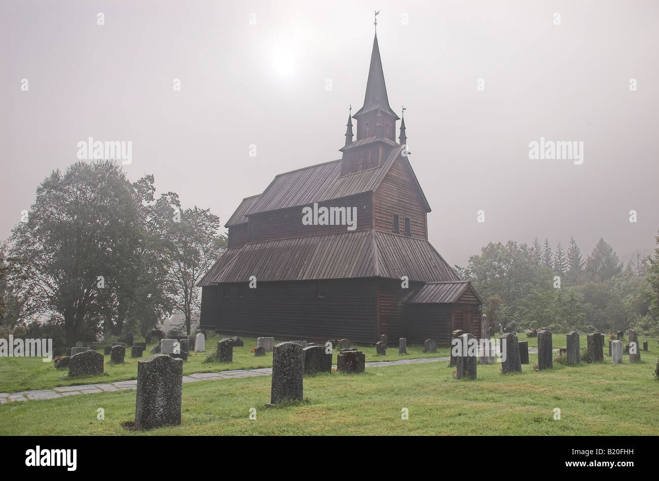 Stave Church, Kaupanger, Sognefjord, Norway in fog with graveyard, side ...