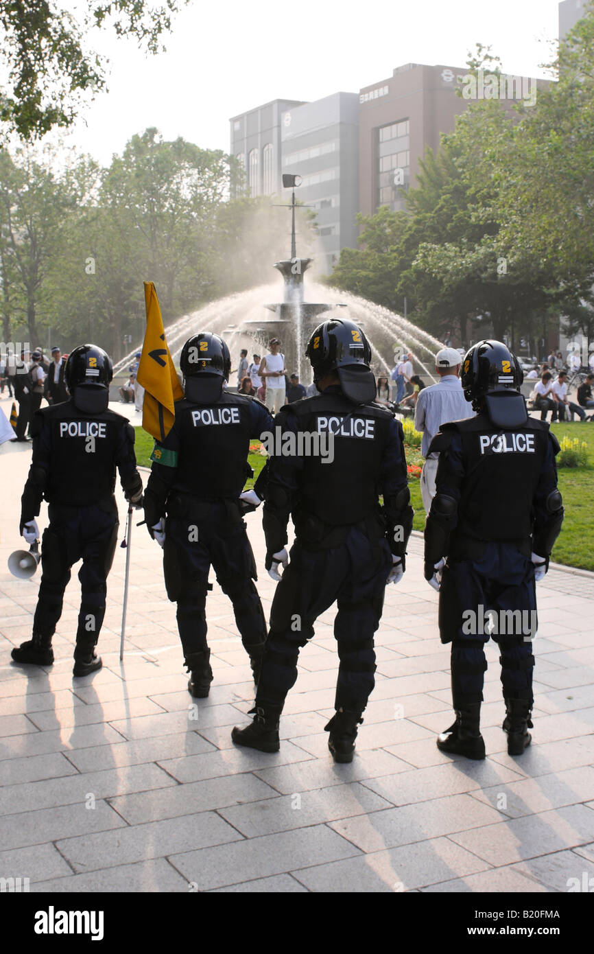 Japanese Police in riot gear admiring a fountain in the Odori Park ...