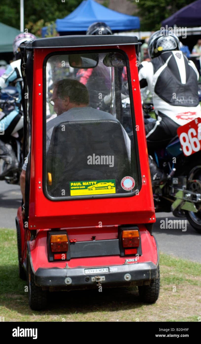 Man driving a battery powered car at a motor race event Stock Photo - Alamy