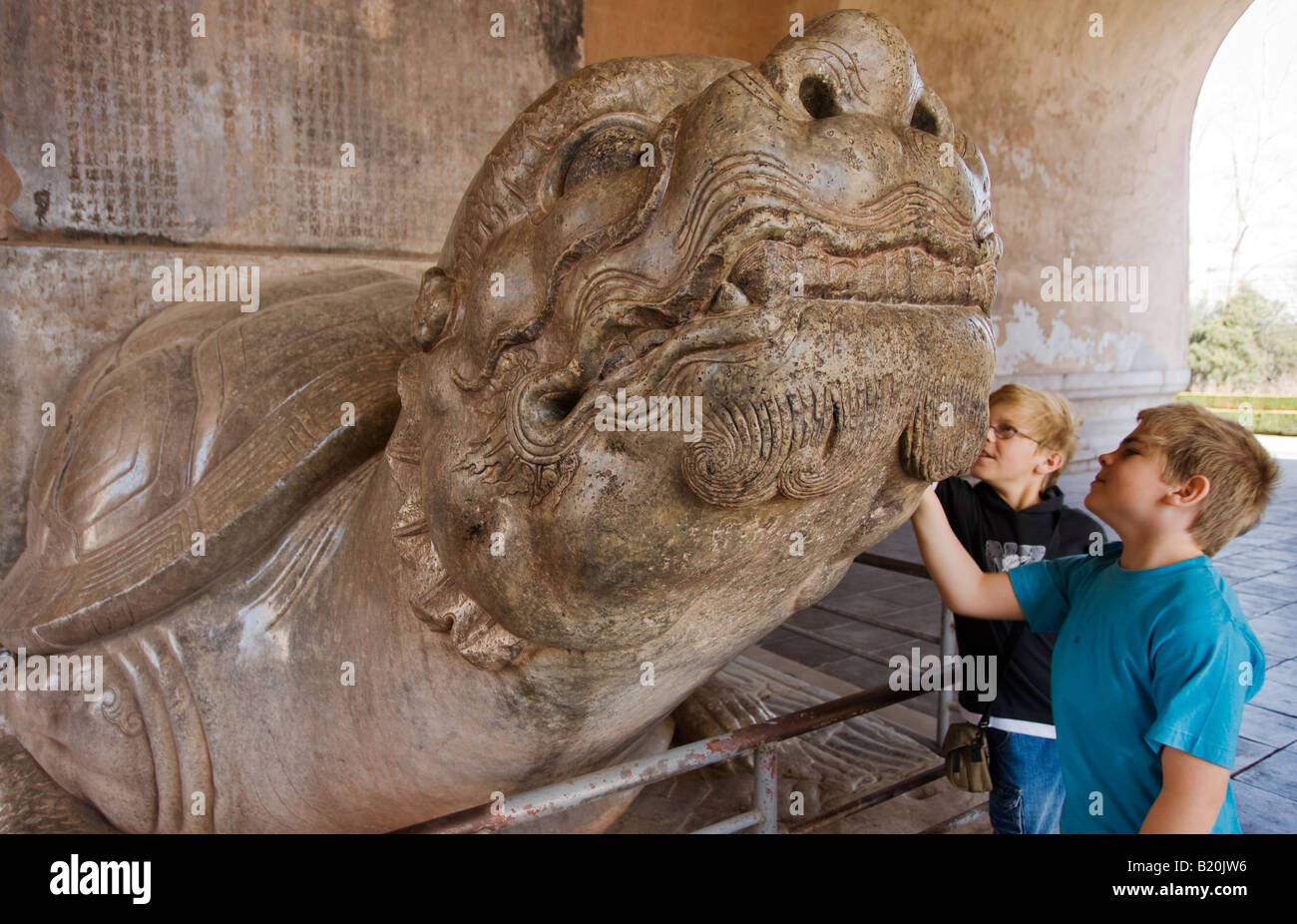 Boys look at turtle statue in the Stele Pavillion at the Ming Tombs ...