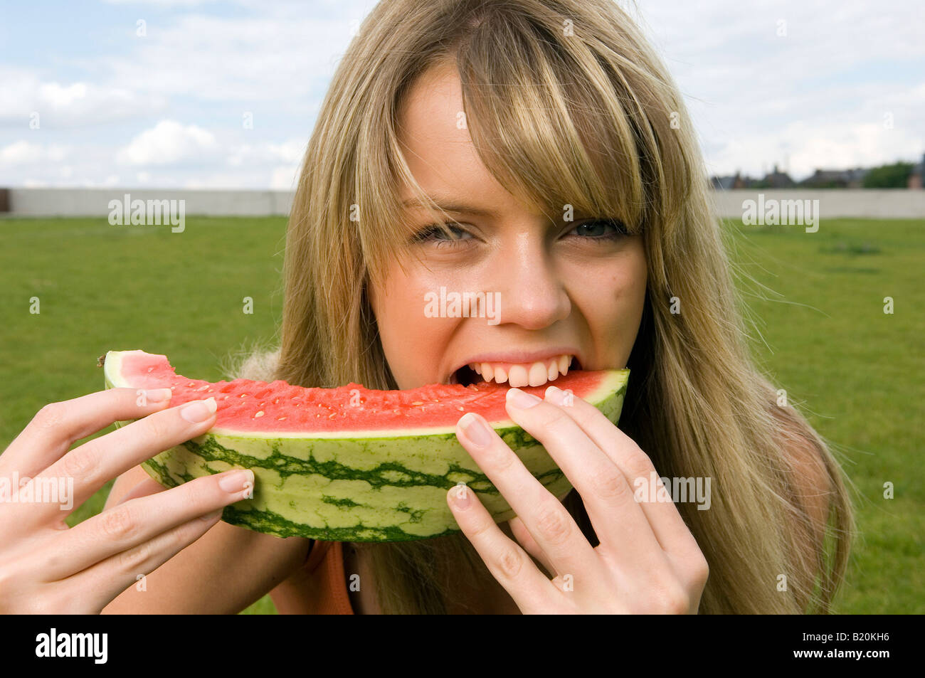 Young woman eating a watermelon Stock Photo - Alamy