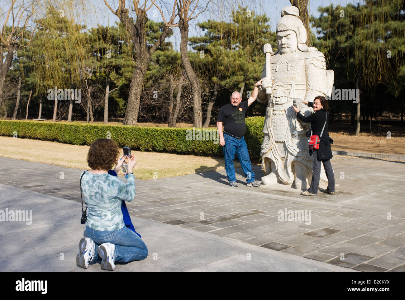 Tourists pose with statue of a military officer on Spirit Way at the ...
