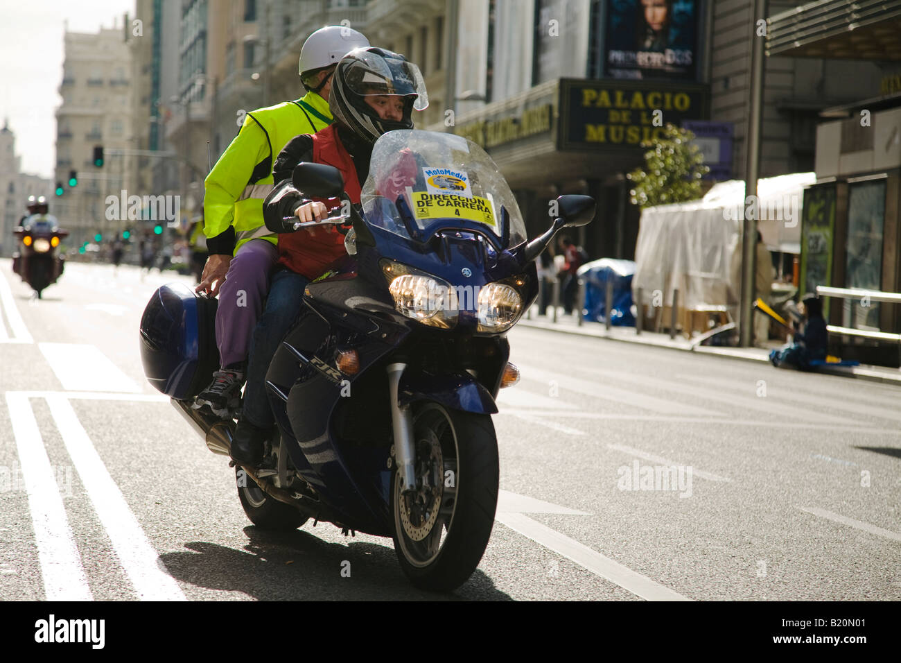 SPAIN Madrid Two men on motorcycle accompany runners in marathon race ...