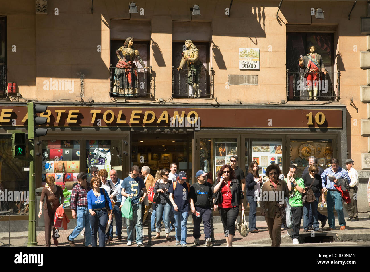 SPAIN Madrid Crowd of people in crosswalk of Paseo del Prado Statues in ...