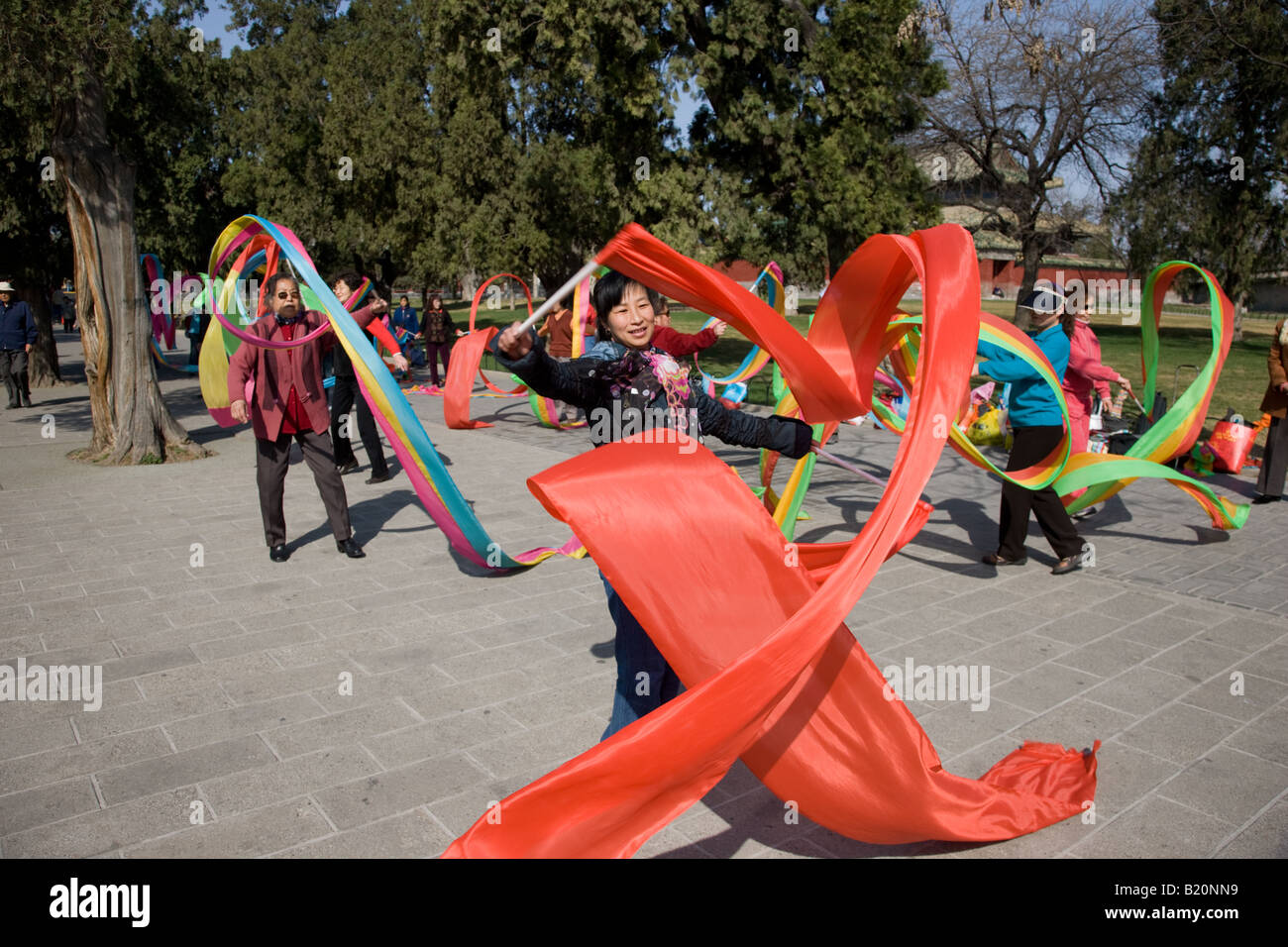 Women practise tai chi dancing with ribbons in park of the Temple of ...
