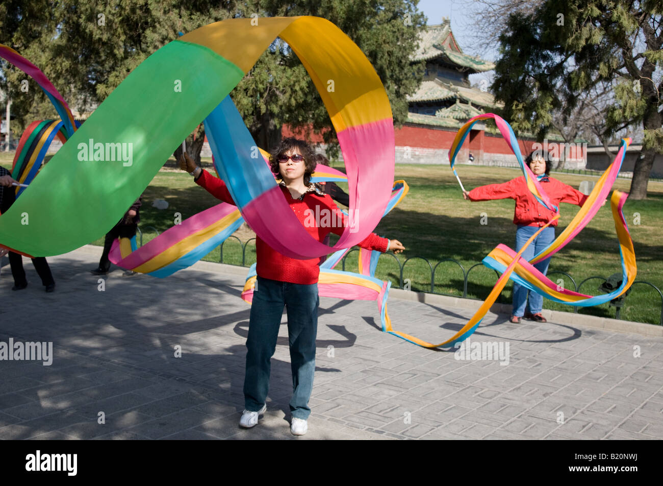 Women practise tai chi dancing with ribbons in park of the Temple of ...