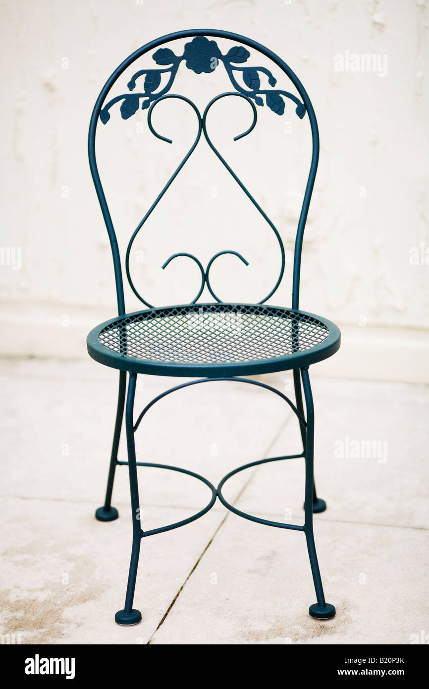 Dark green metal chair with scroll work Stock Photo - Alamy