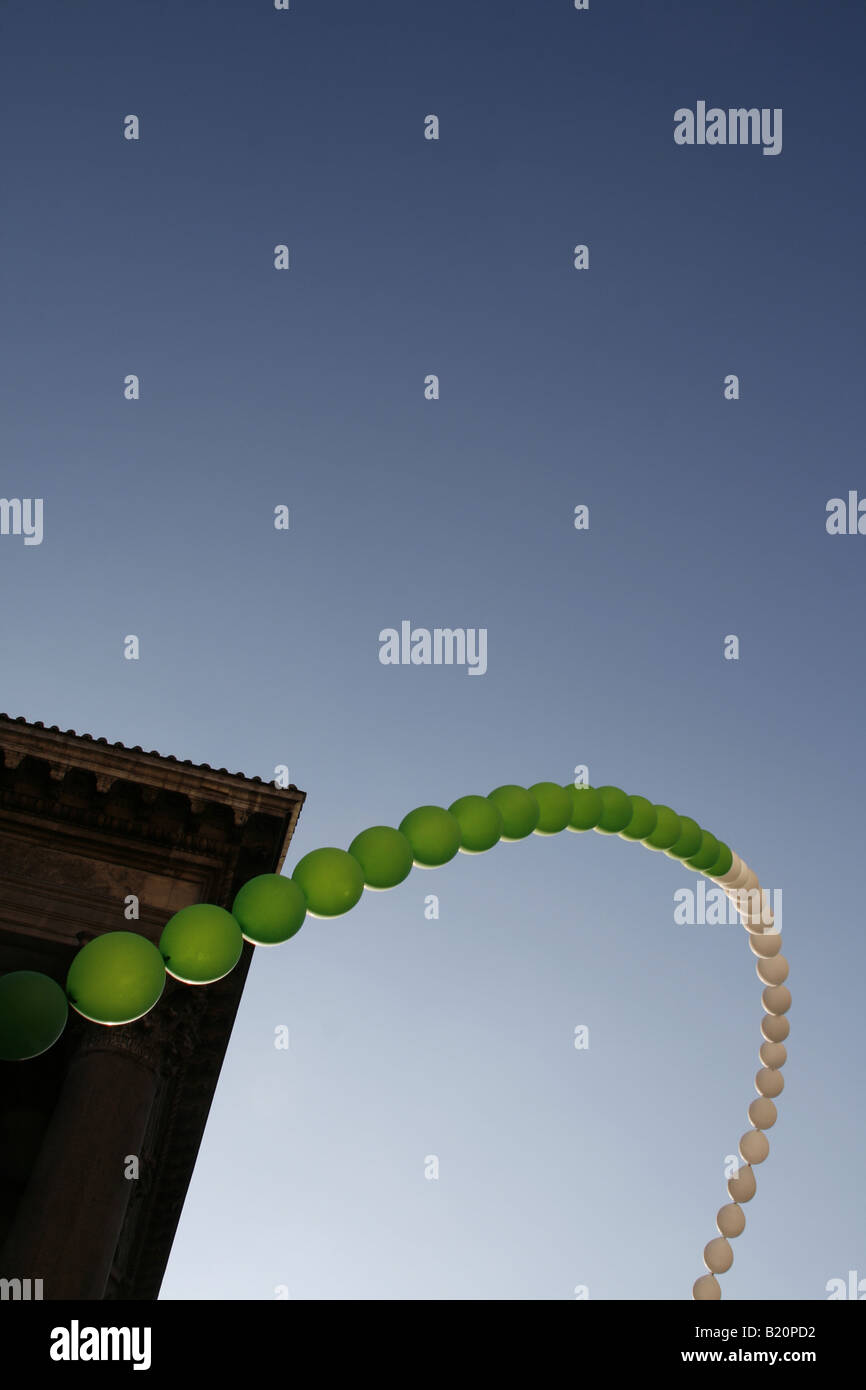 long line of green white balloons in blue sky Stock Photo - Alamy