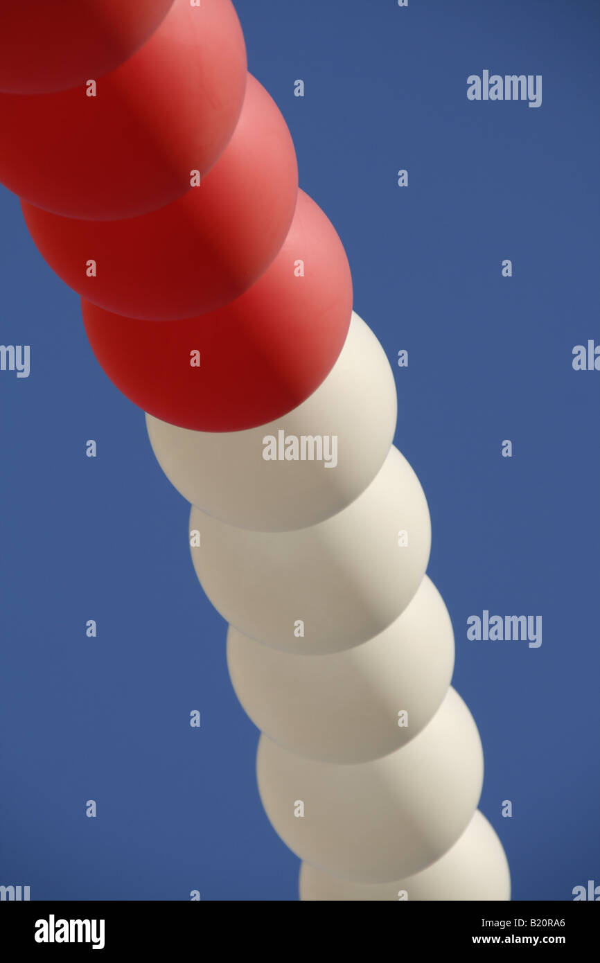 long line of red white balloons in blue sky Stock Photo - Alamy