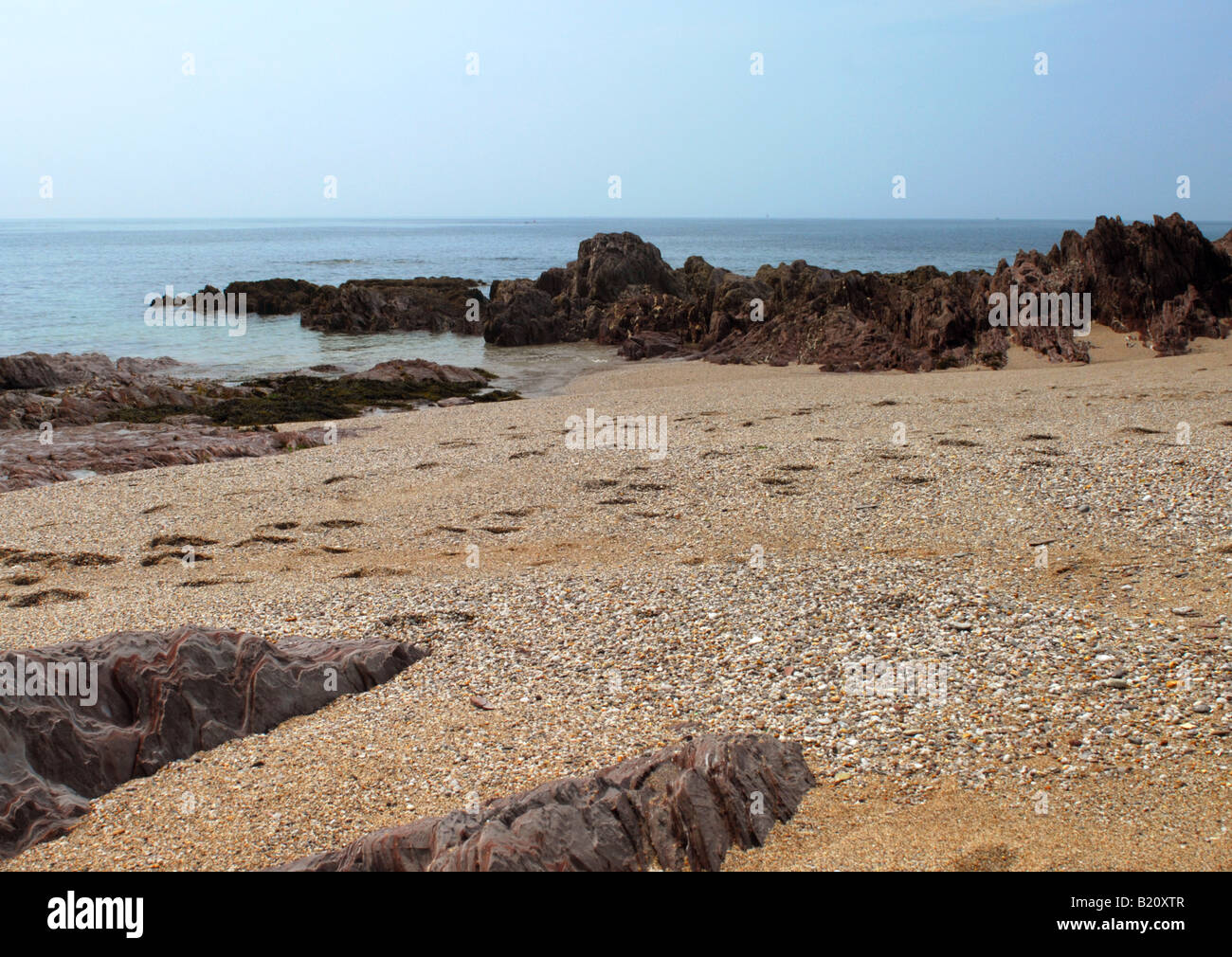 The shingle beach and rocky shoreline near Thurlestone in South Devon ...