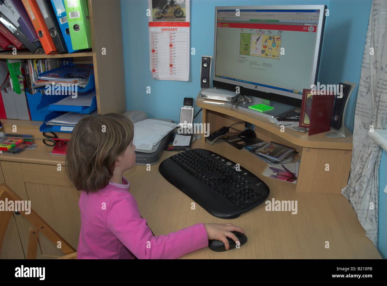 Girl age 5 Using A Computer Stock Photo - Alamy