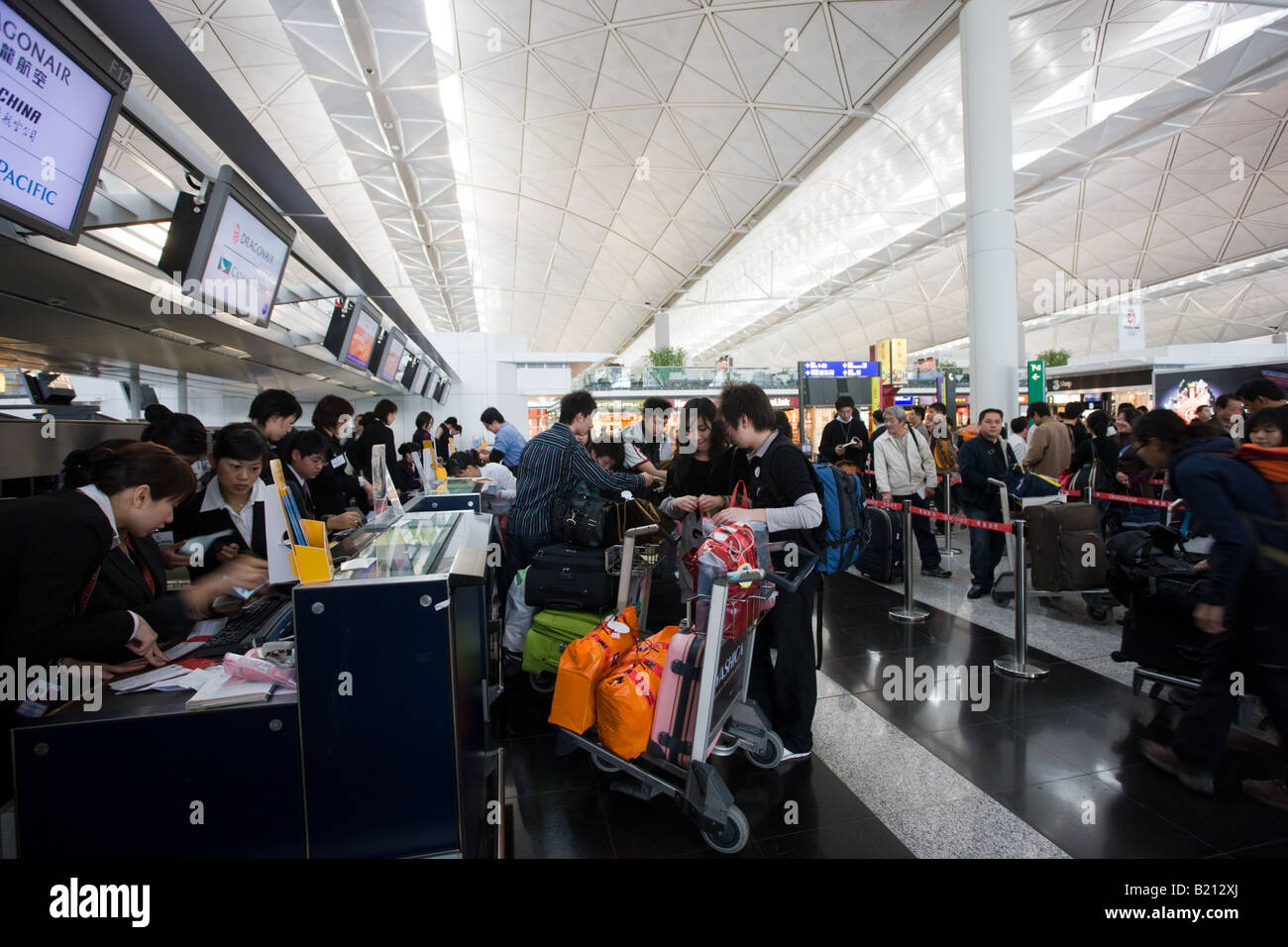 Passengers at check in desks Hong Kong International Airport China ...