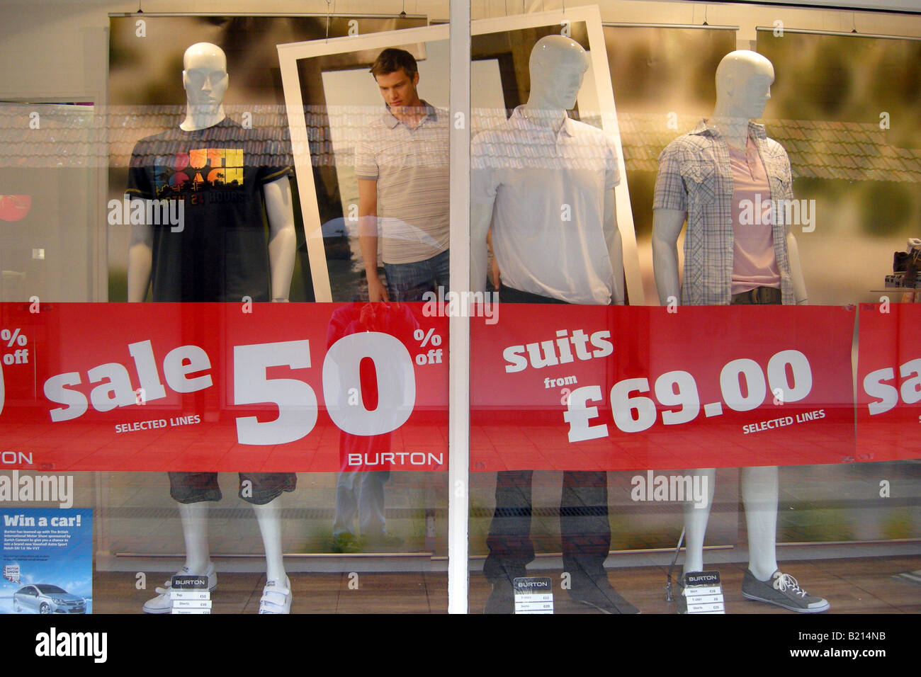 Savings posters in the window of a high street store trying to entice ...