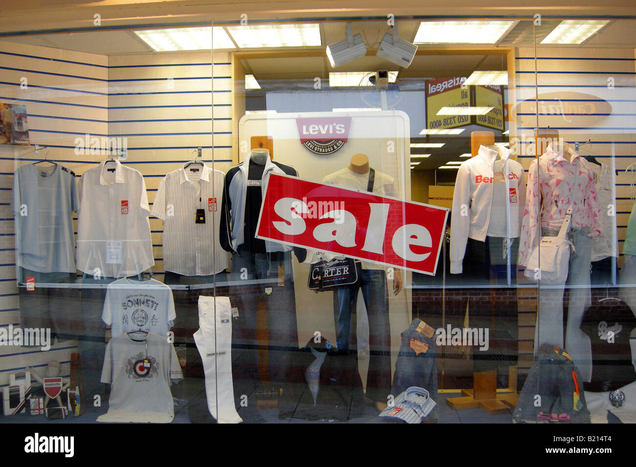 Savings posters in the window of a high street store trying to entice ...