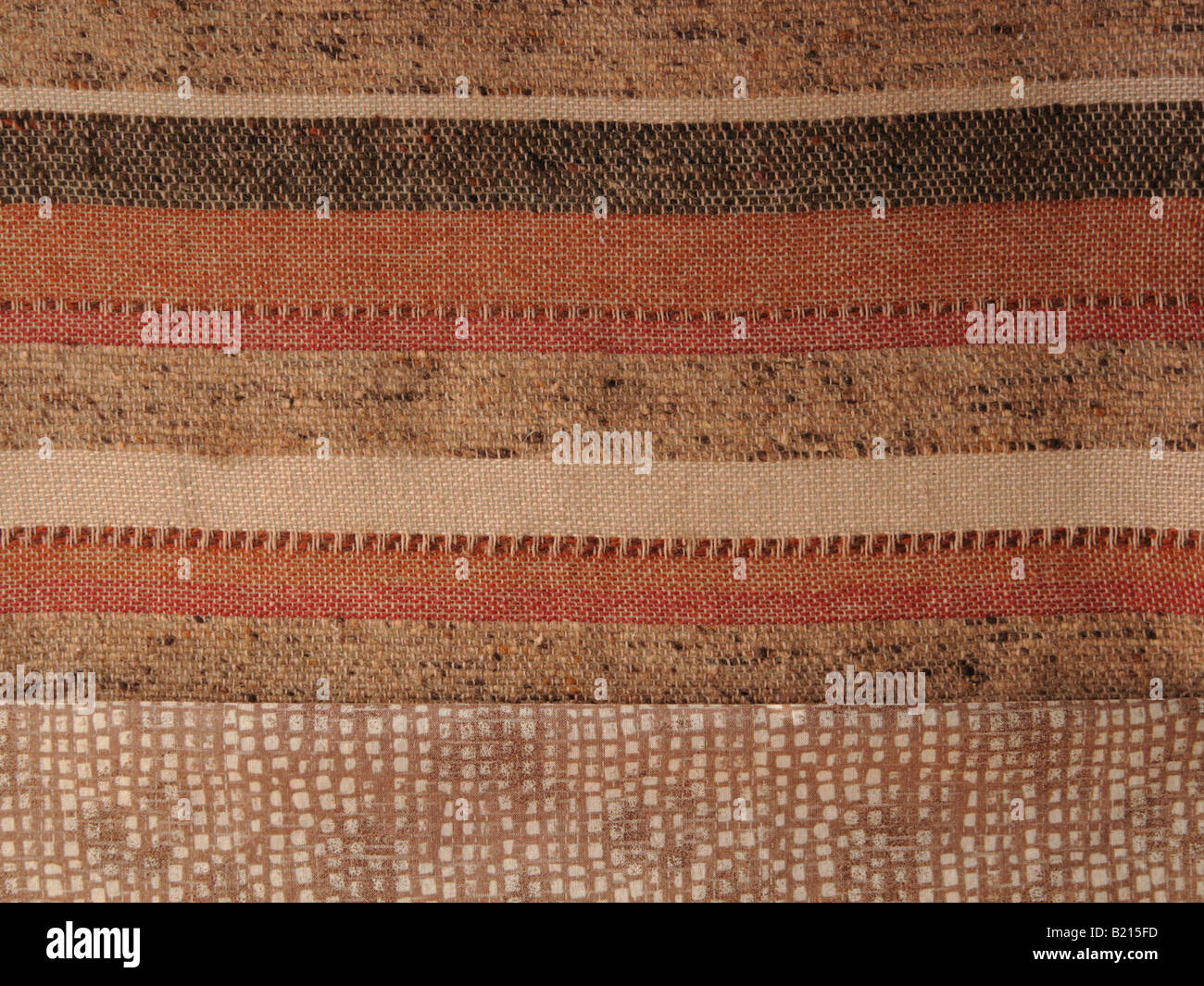 a textured fabric and a cotton print fabric, both in neutral shades ...