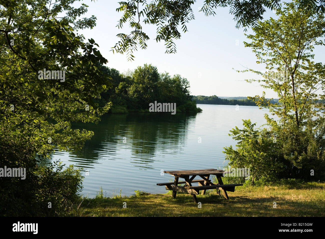 A lake with picnic table Stock Photo - Alamy