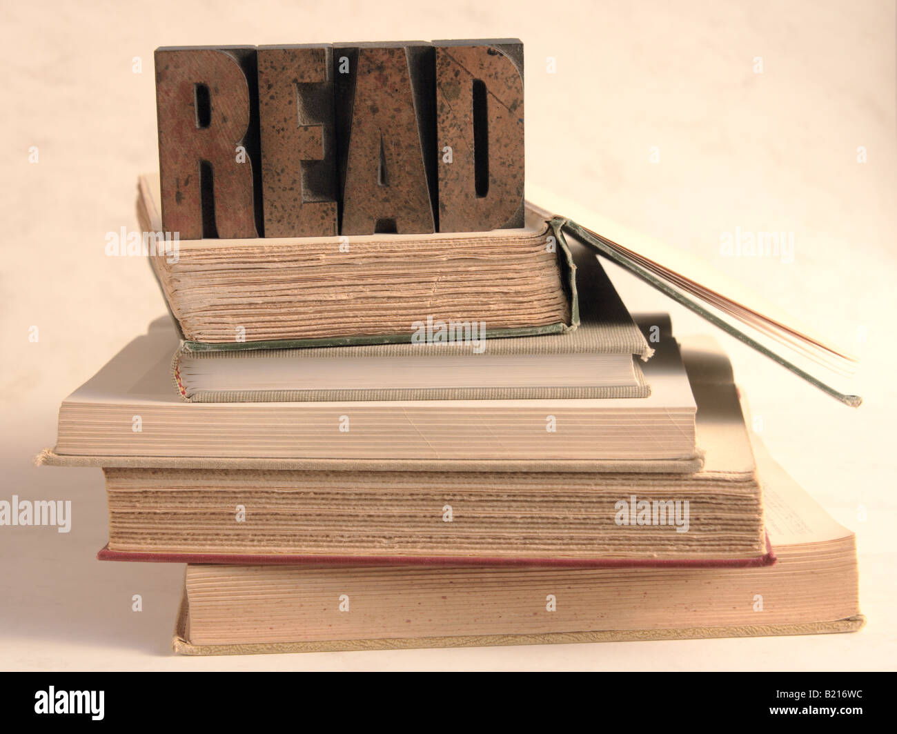 the word 'read' in ink-stained letterpress type atop a stack of old ...