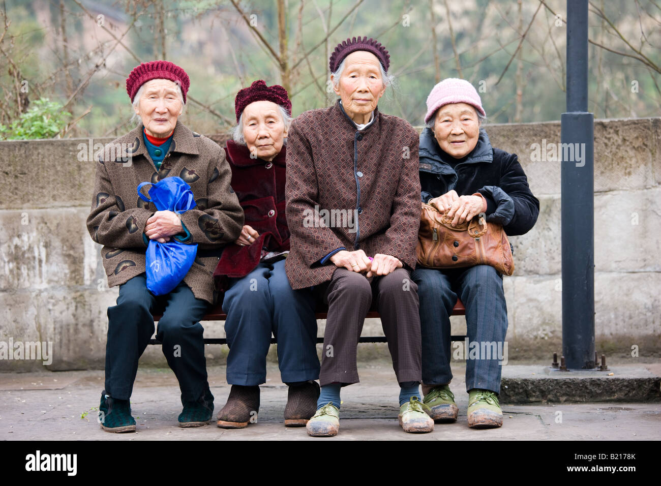 Elderly Chinese women sit together on a bench in Chongqing China Stock ...
