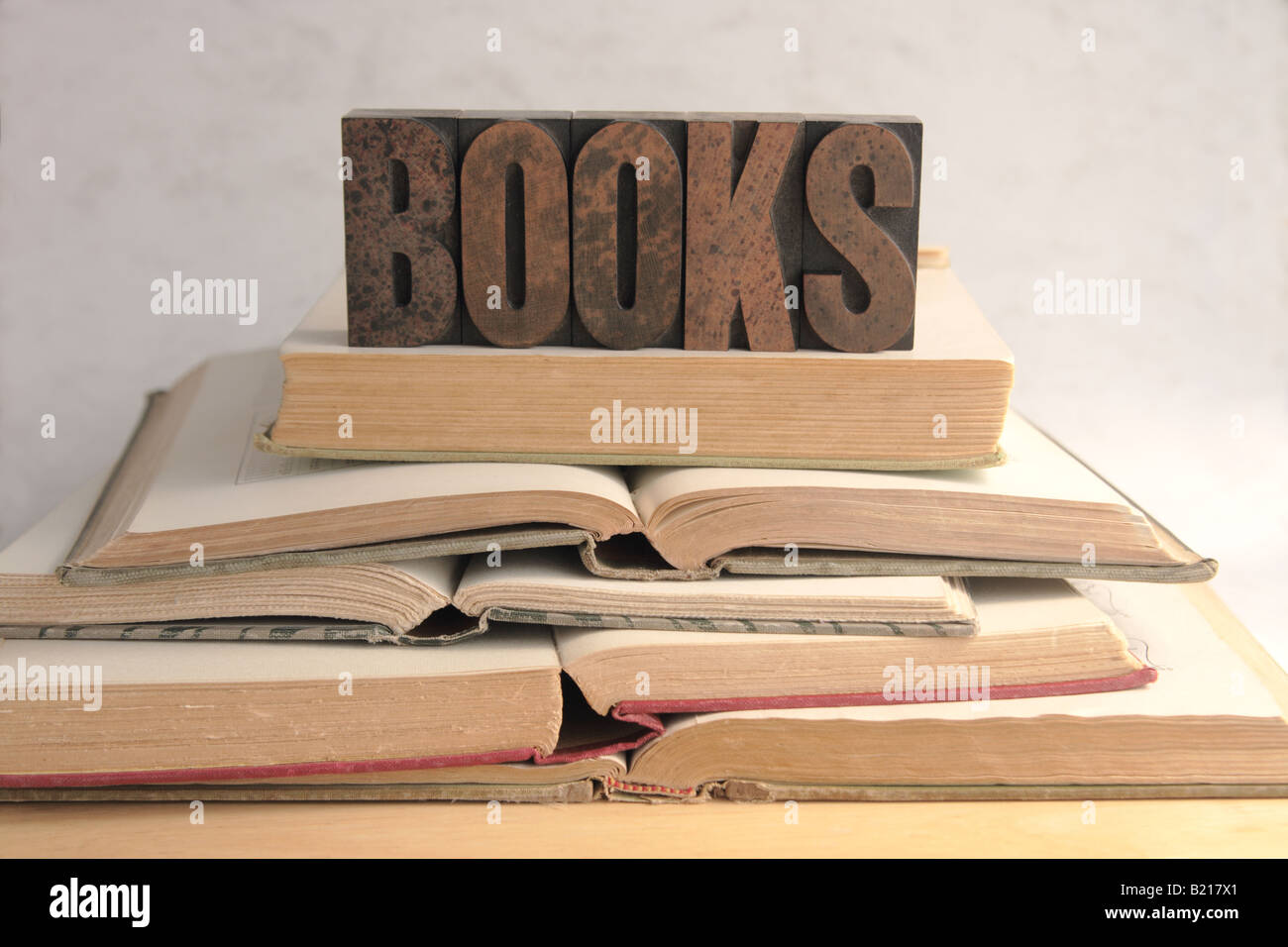 the word 'books' in ink-stained letterpress wood type on top of a stack ...