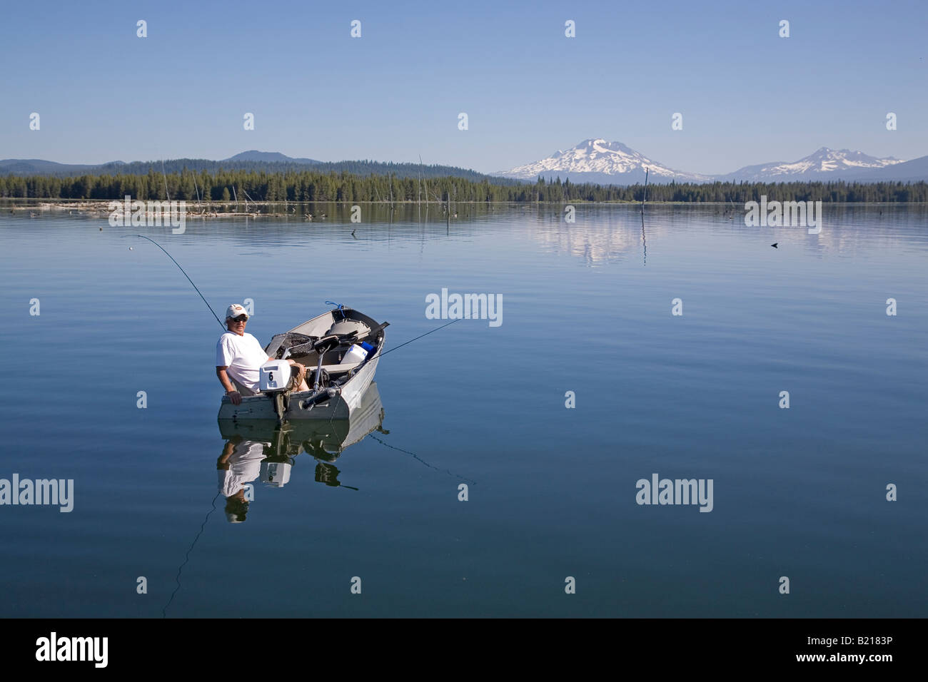 A fisherman fishes for rainbow and brown trout on a summer morning on ...