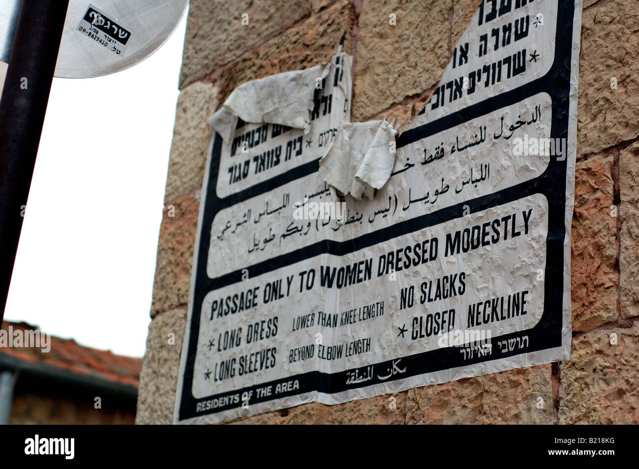 A torn sign in the Nahla'ot neighborhood of Jerusalem requesting that ...