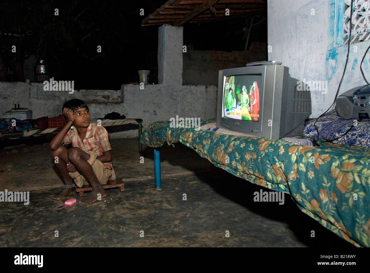 Rajasthani girl watching a traditional television programme on a tv set ...