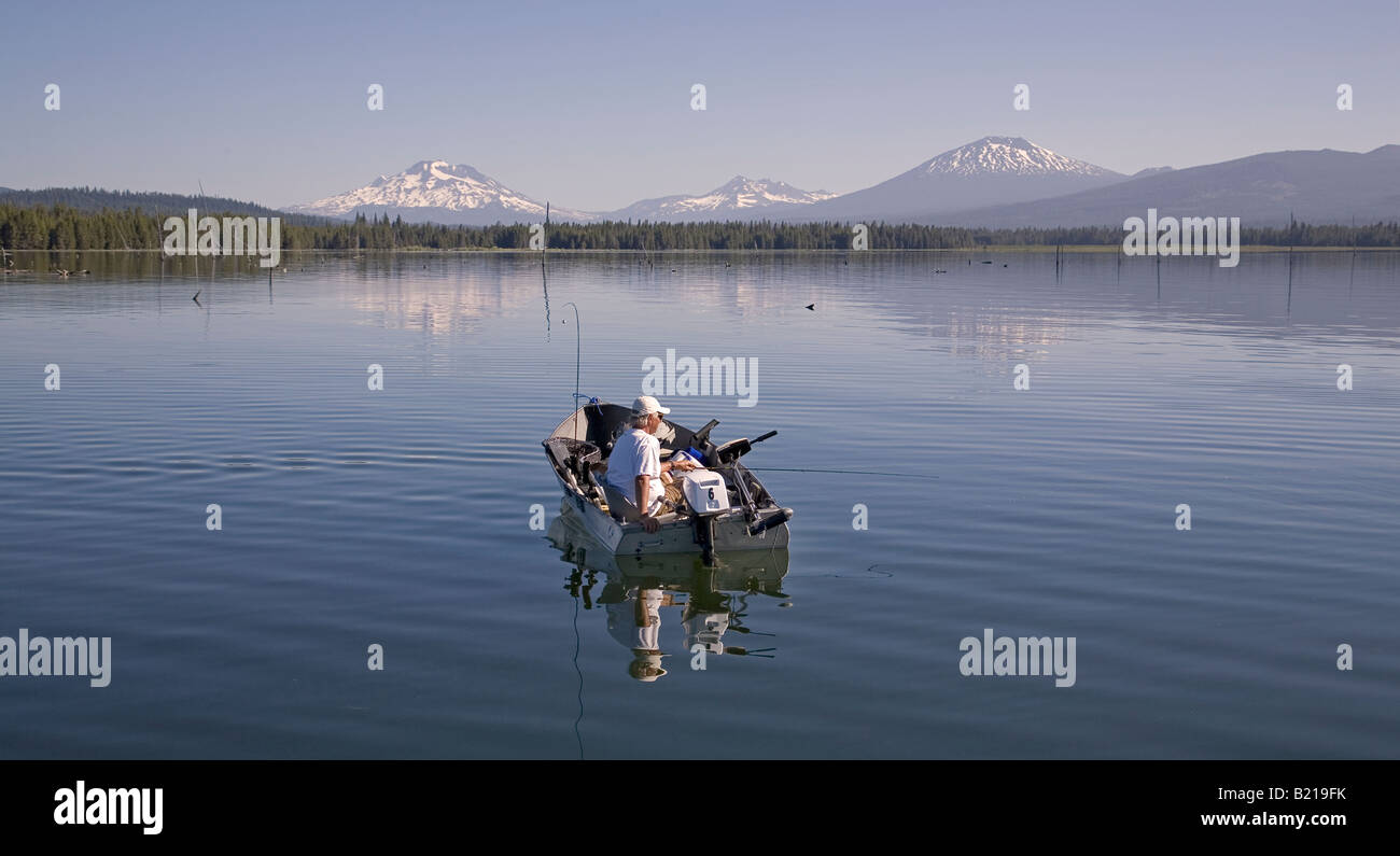 A fisherman fishes for rainbow and brown trout on a summer morning on ...