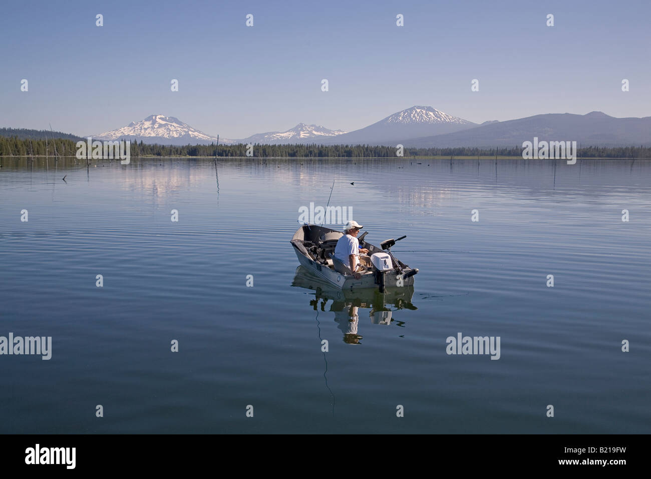 A fisherman fishes for rainbow and brown trout on a summer morning on ...