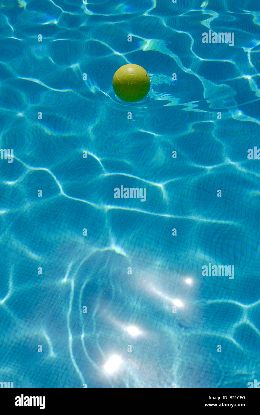 yellow water polo ball on the surface of a blue swimming pool Stock ...