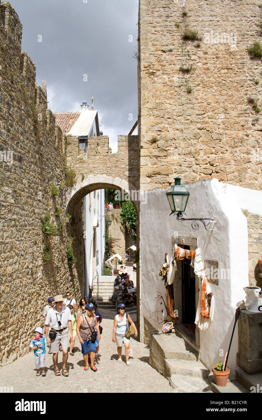 Typical street of Obidos near the castle fortifications. Obidos is a ...