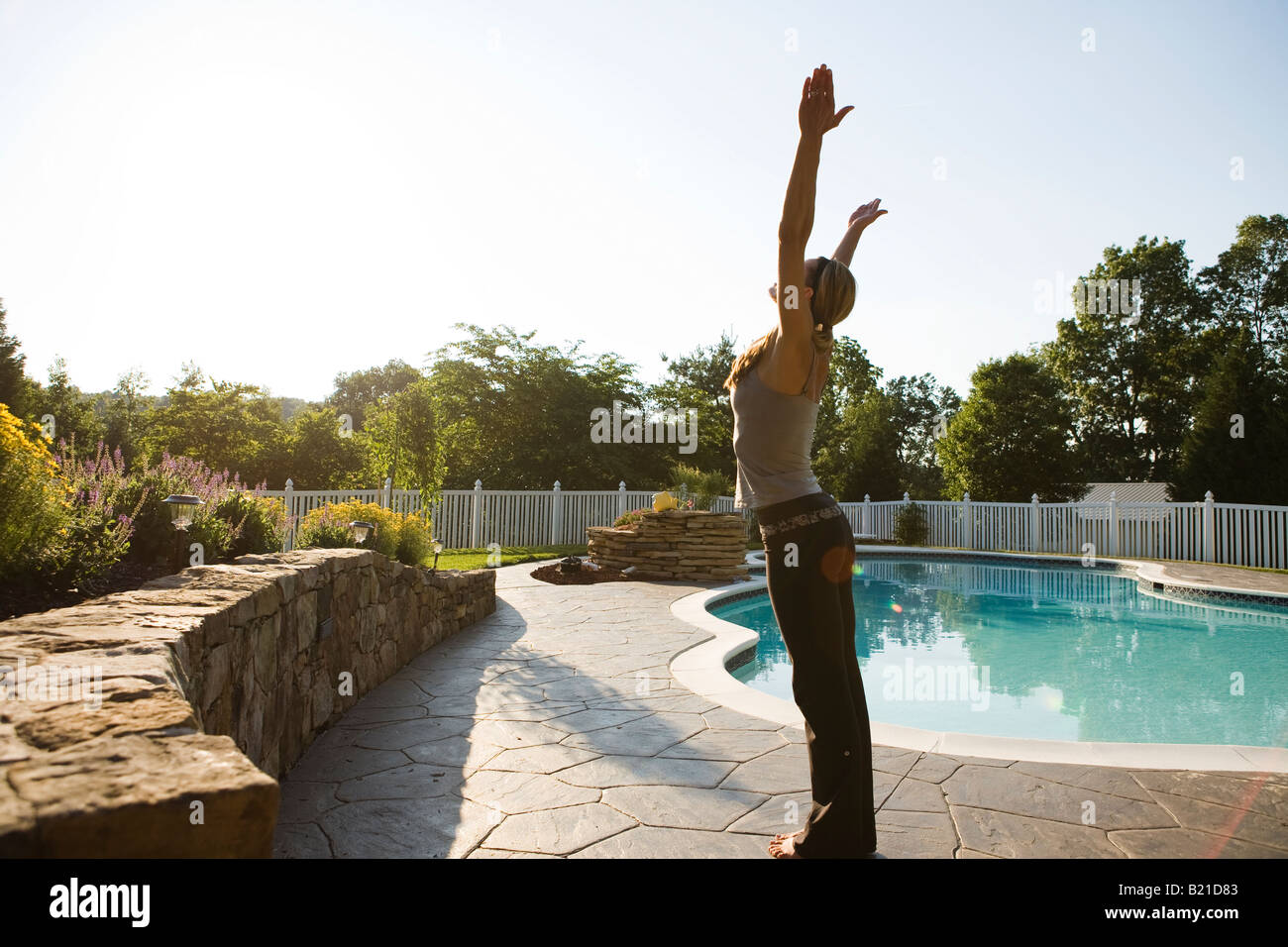 A woman doing yoga by a pool Stock Photo - Alamy