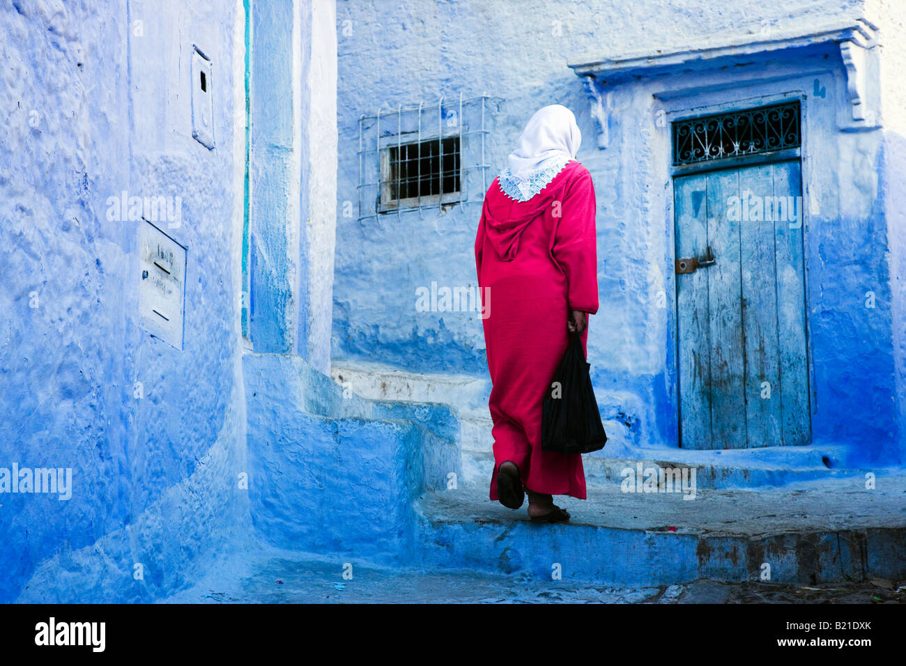 Chefchaouen woman in traditional dress in the old town with typical ...
