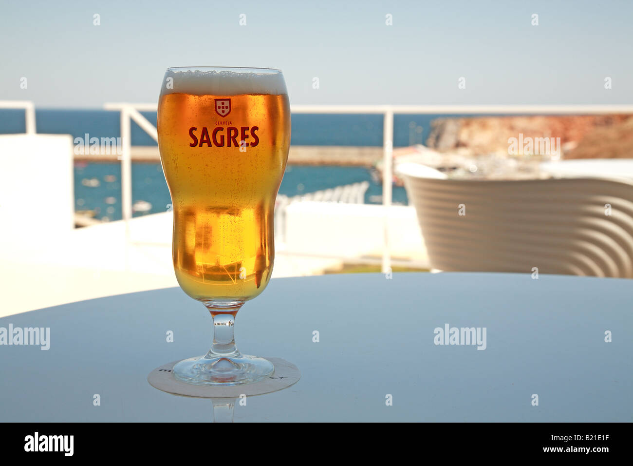 A glass of Sagres beer on a table at Sagres, Algarve, Portugal Stock ...