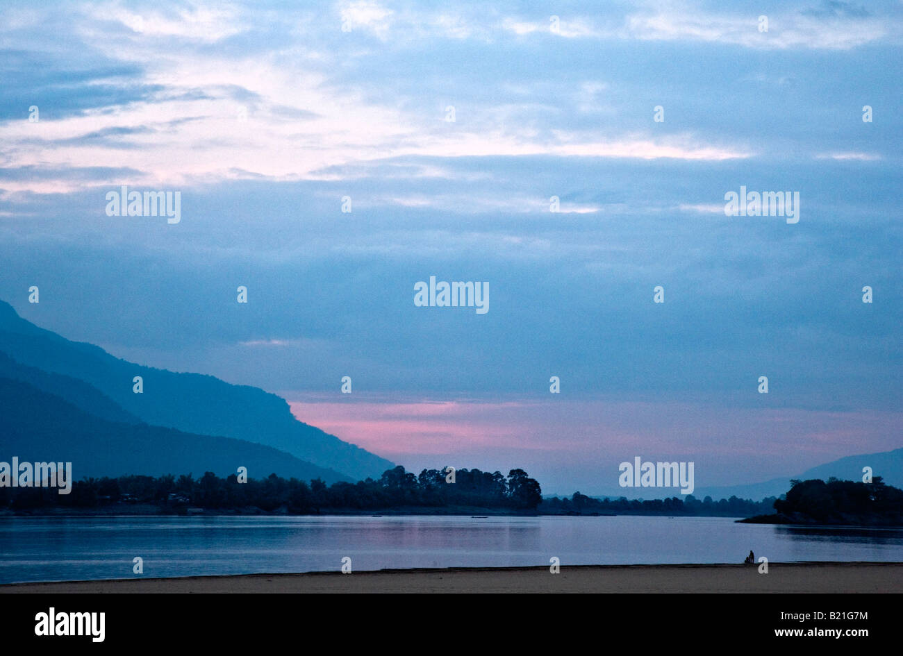 Fishermen bringing in nets from the Mekong River at sunset, Don Daeng ...