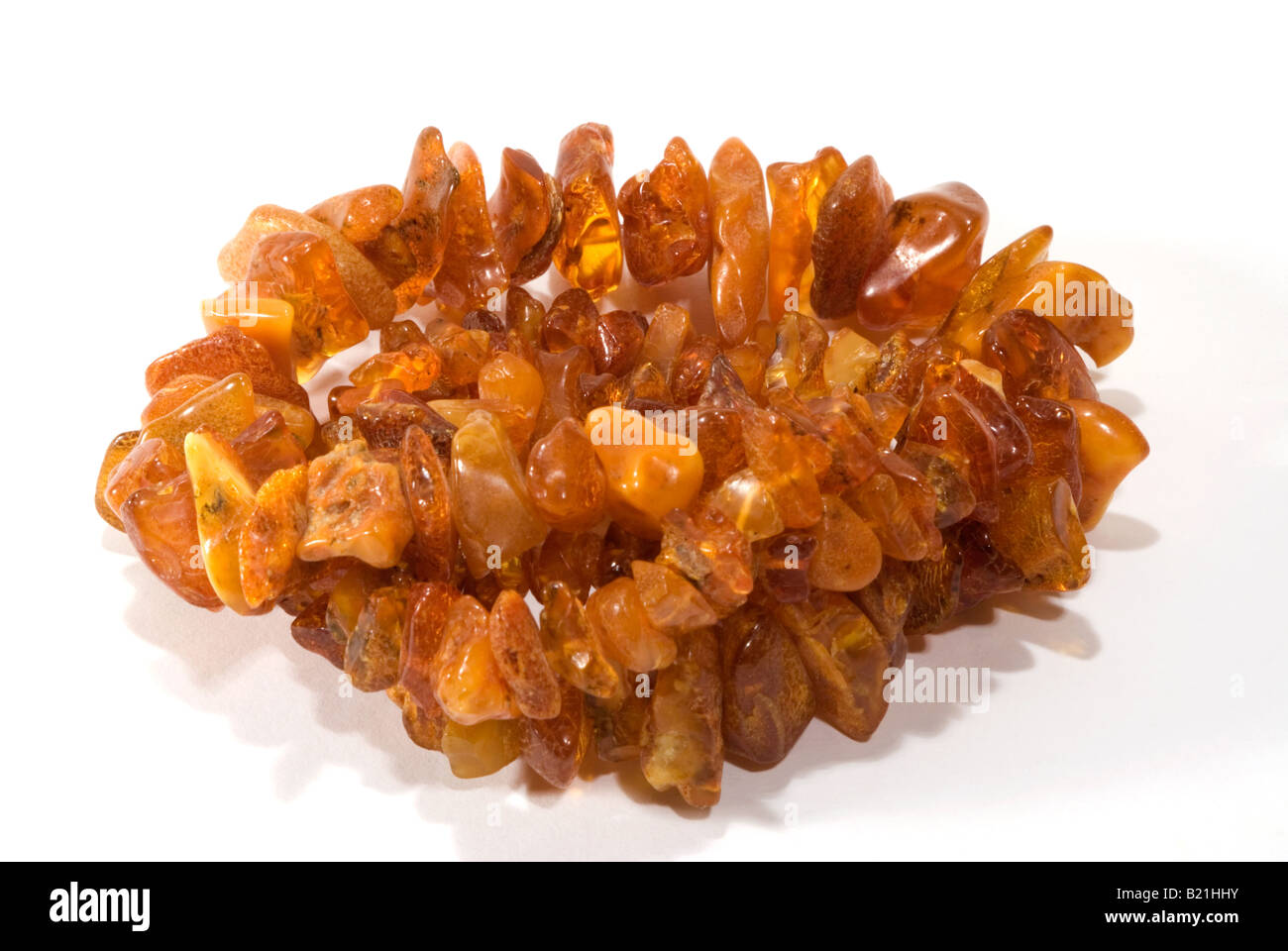 thread of amber bead on white background close up Stock Photo - Alamy