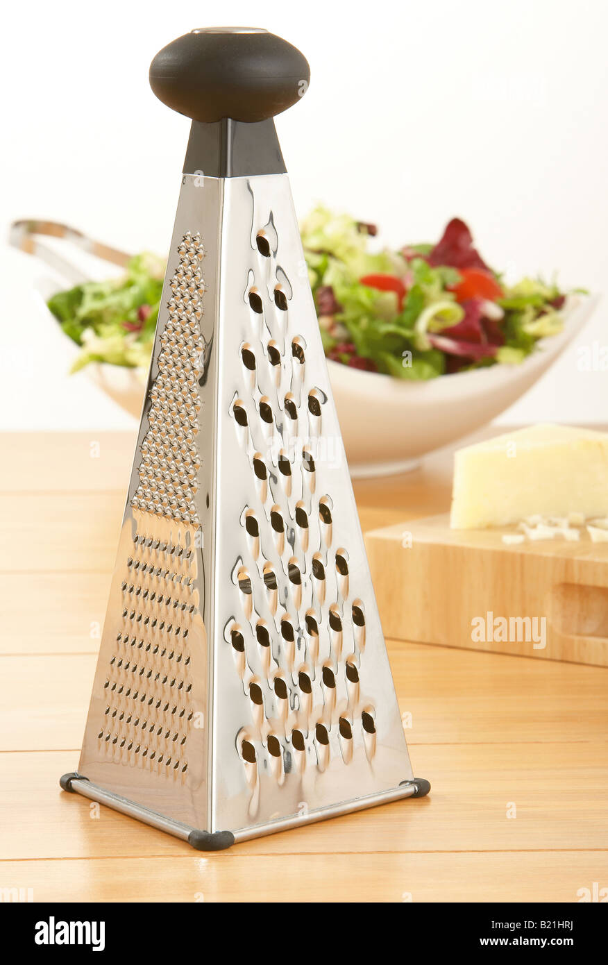 Cheese grater with ingredients in the backgound Stock Photo - Alamy