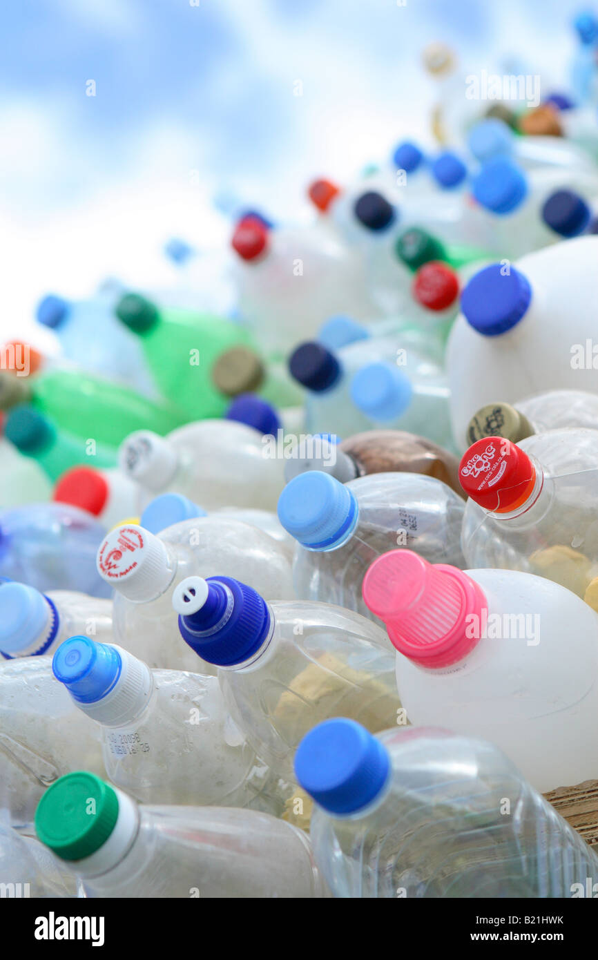 Pile stack of assorted plastic bottles with colourful lids at waste ...