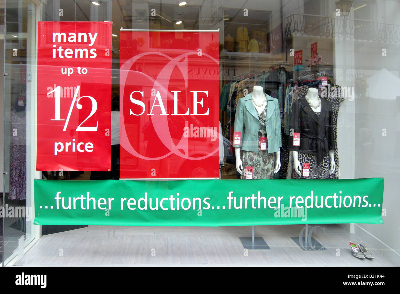 Savings posters in the window of a high street store trying to entice ...